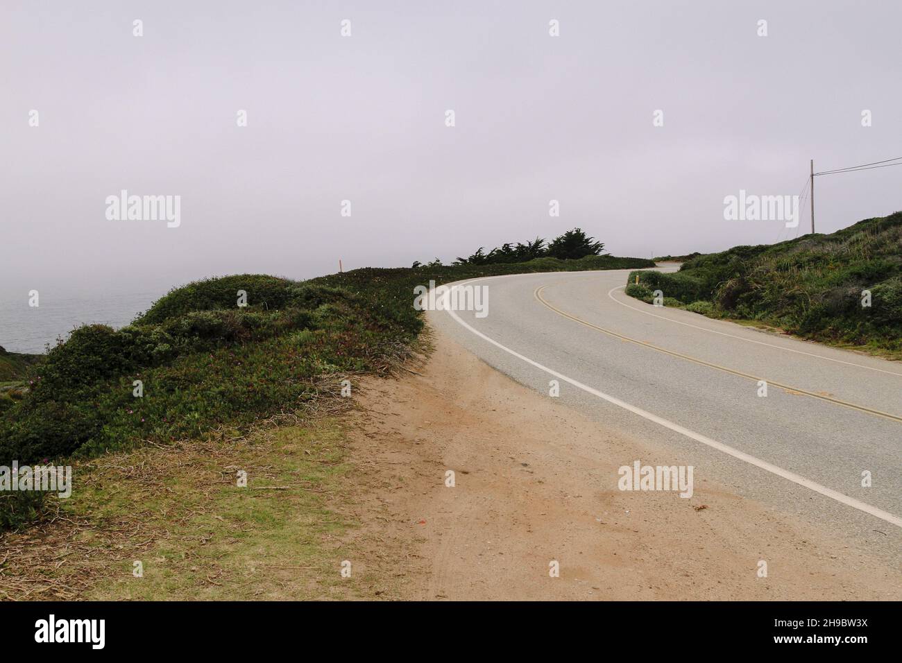 Empty highway and bushes under a clear sky in Big Sur, California Stock ...