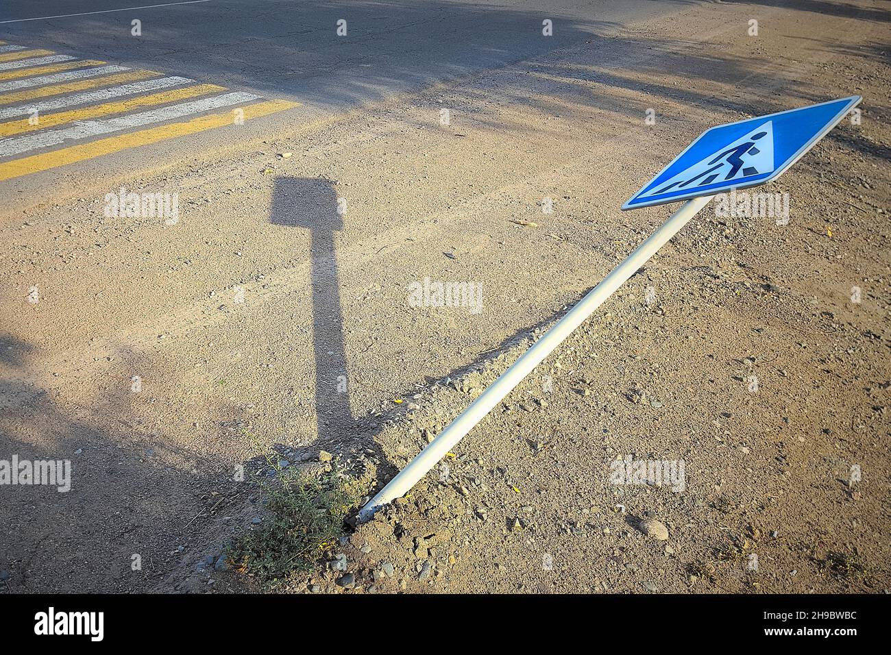 Accident at a pedestrian crossing. Downed pedestrian crossing road sign ...