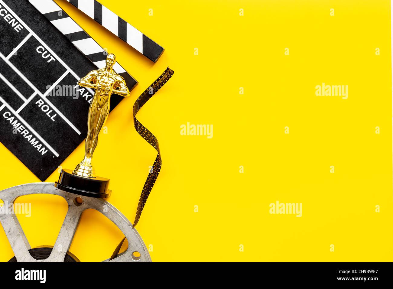 Film reel video tape with golden statue and movie clapper board Stock ...