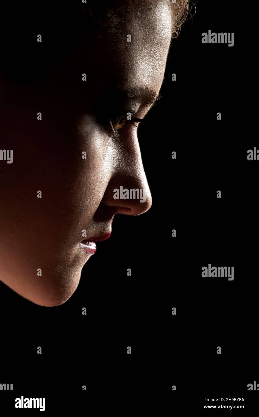 sad serious woman on black background looking aside, profile view Stock ...