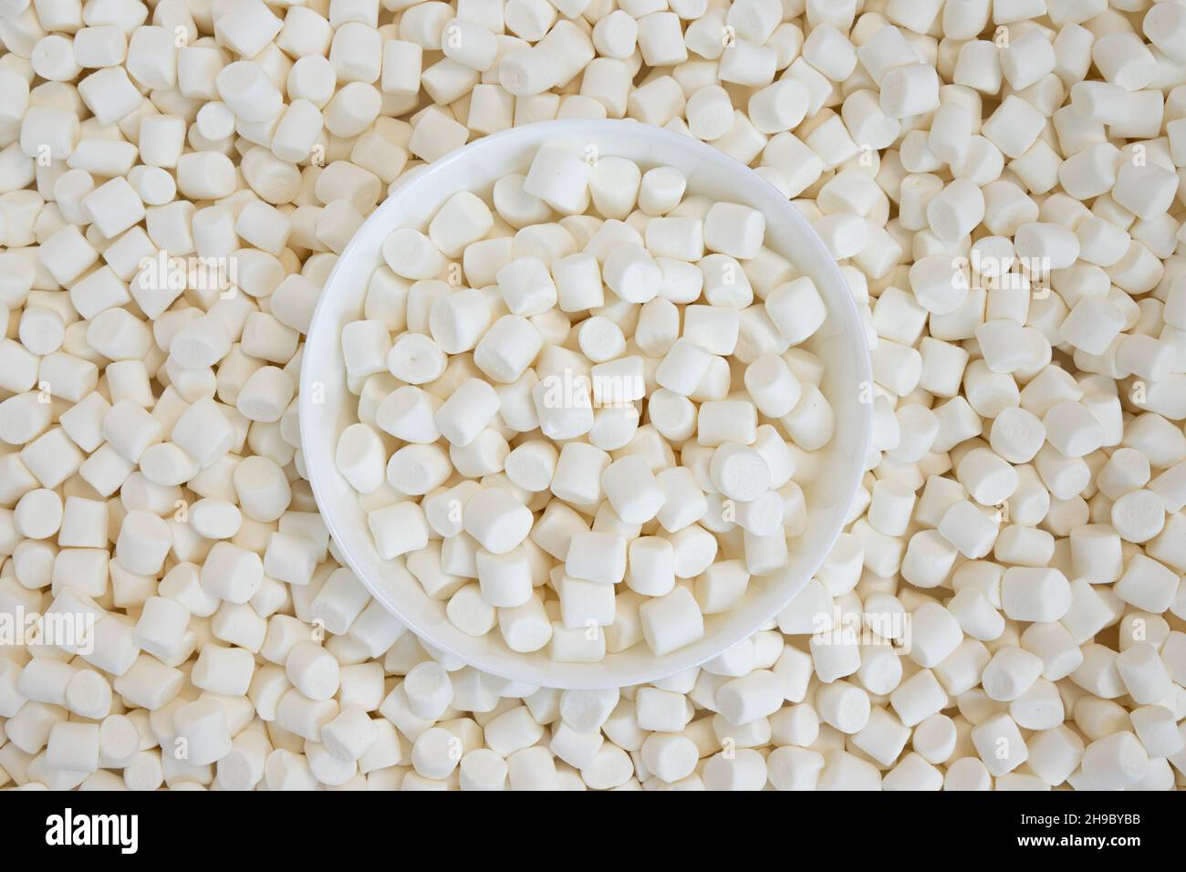sweet airy soft white marshmallows lying in bowl, texture of white mini ...