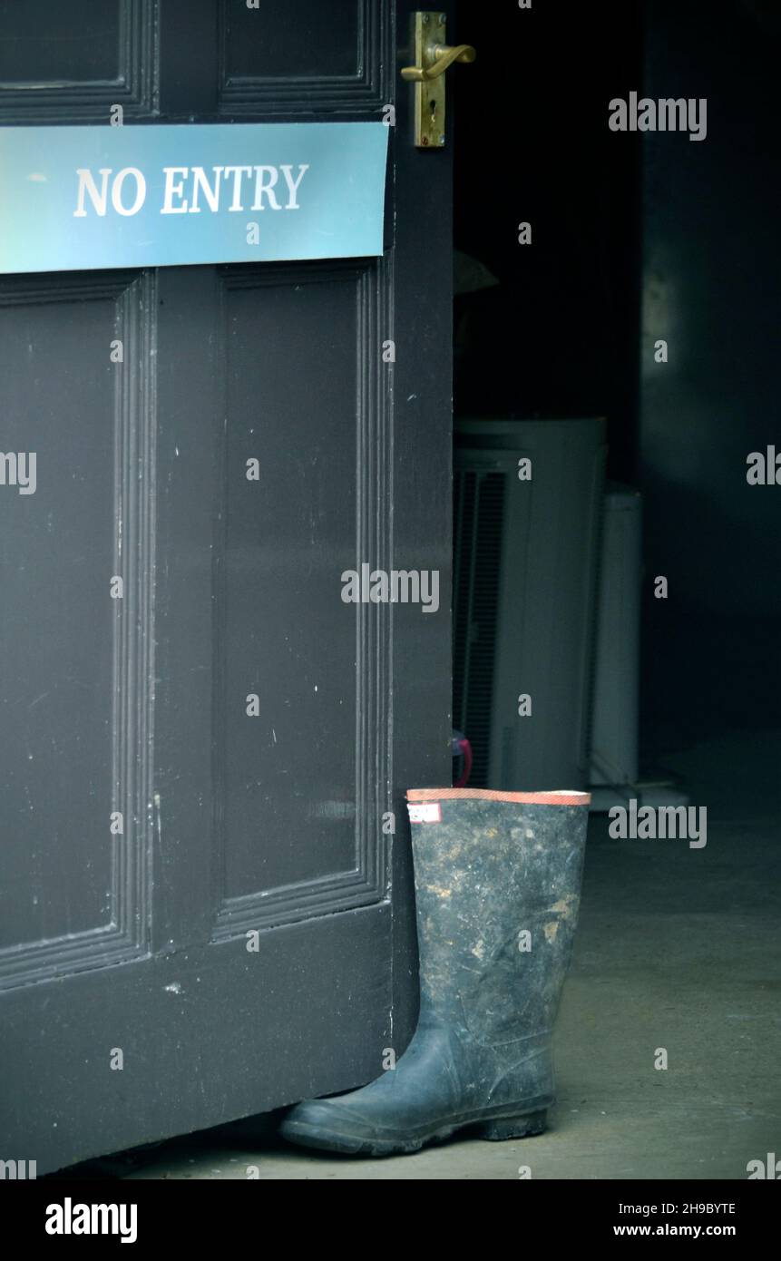 door with no entry sign held open by wellington boot Stock Photo - Alamy
