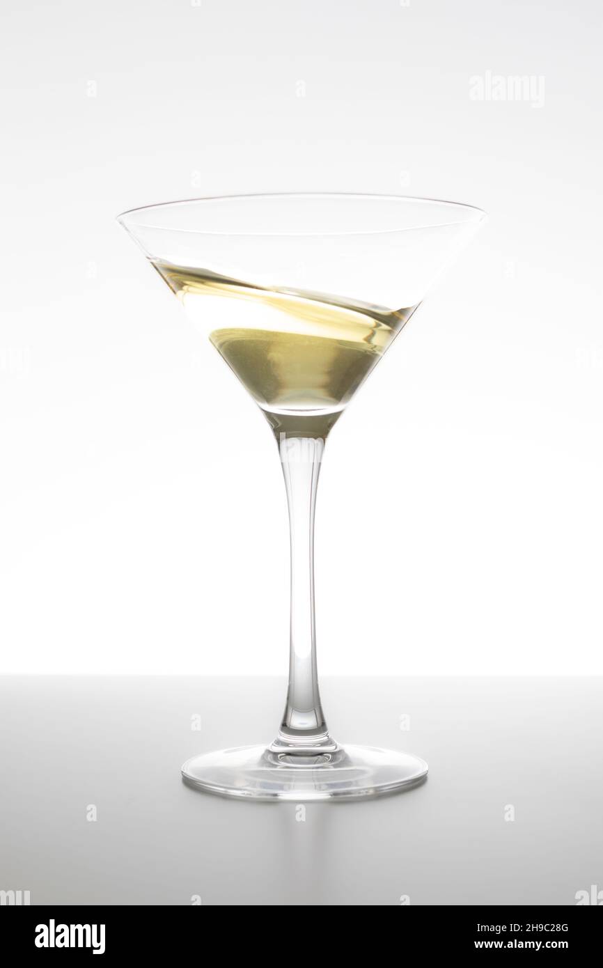 Vermouth glass in motion on white background Stock Photo - Alamy