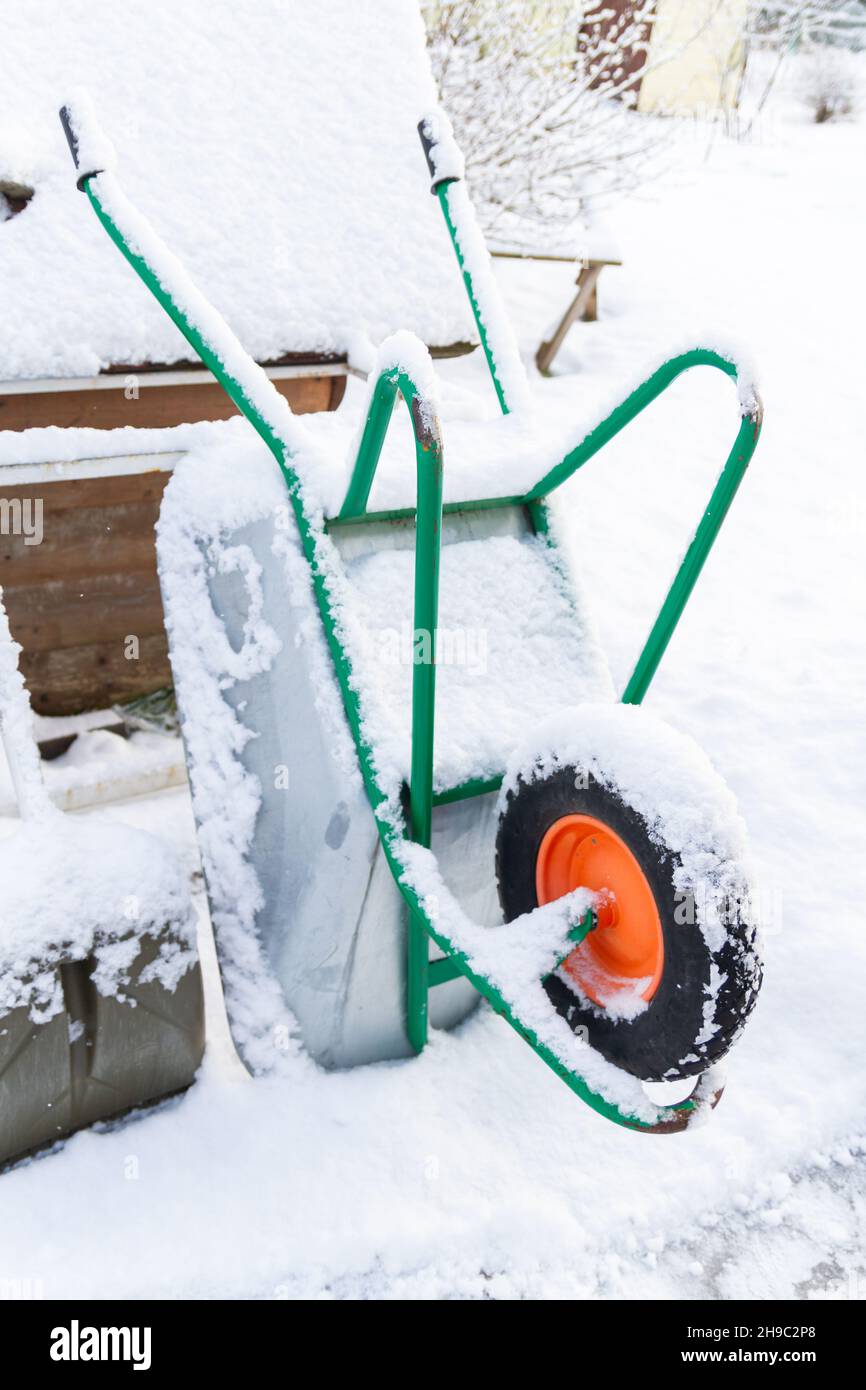 Metal garden wheelbarrow in the snow in winter Stock Photo - Alamy