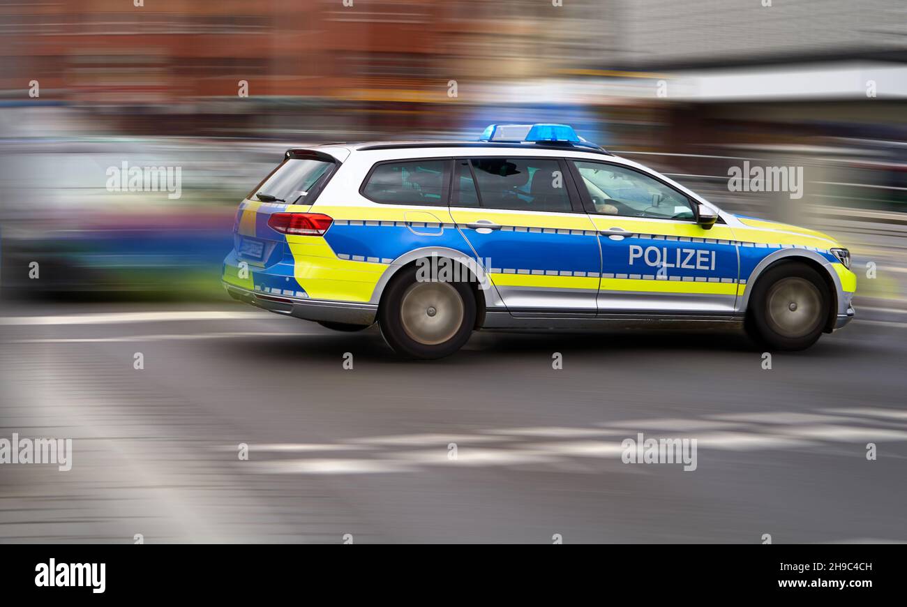 German police emergency vehicle with blue lights on speeds through an ...