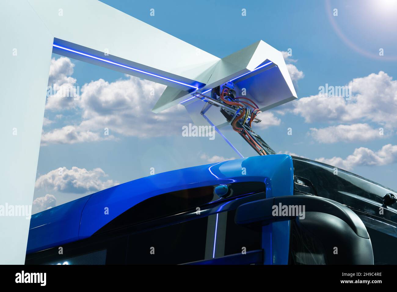 Electric bus at a stop is charged by pantograph Stock Photo - Alamy
