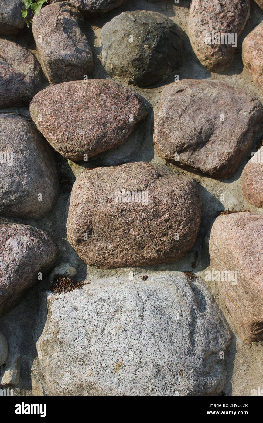 Stone wall made of huge boulders in the bright sunshine Stock Photo - Alamy