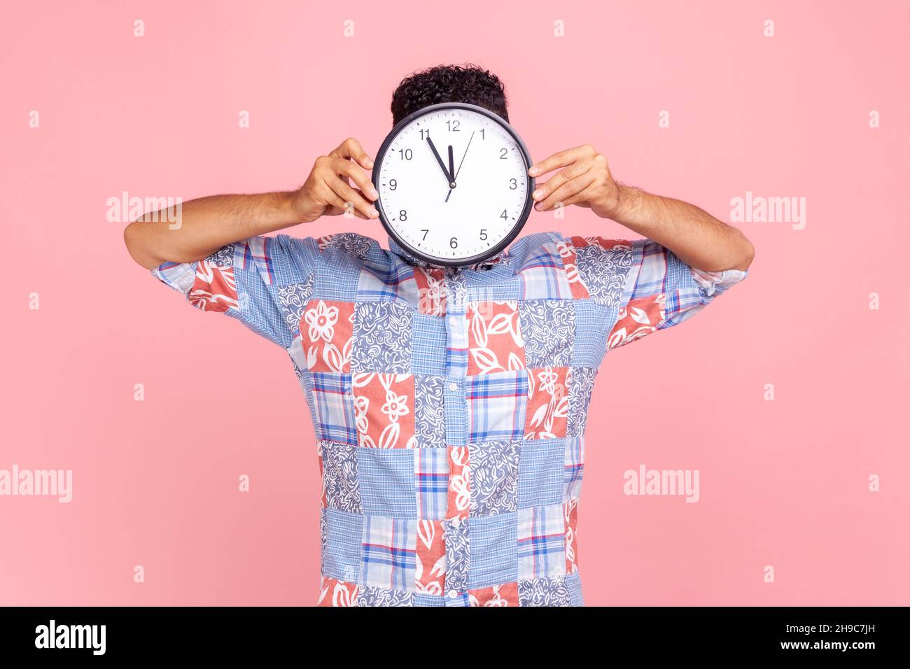 Unknown man in blue casual style shirt hiding face behind big wall ...