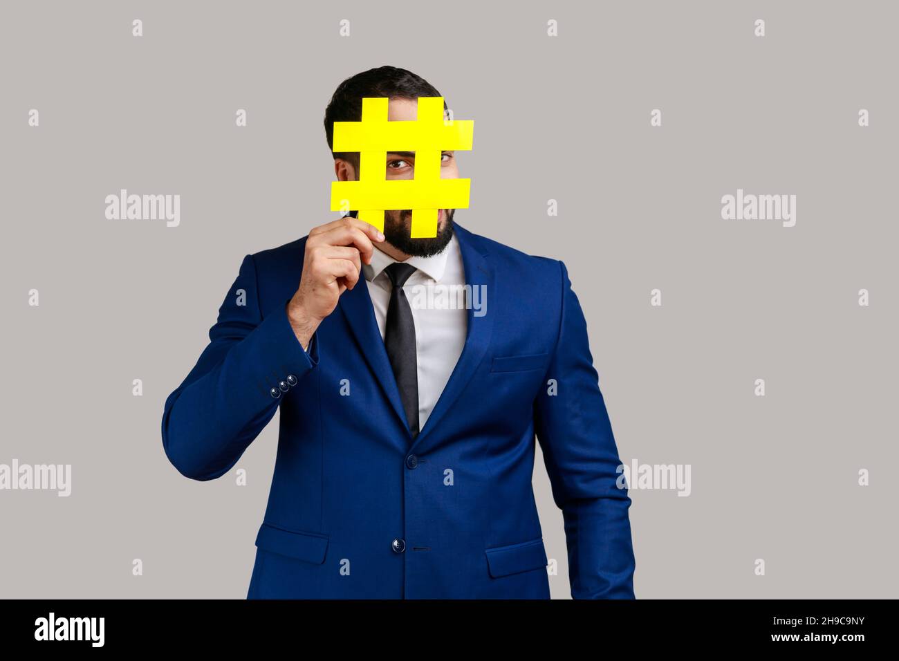 Man covering face with social media hashtag symbol, recommending to ...