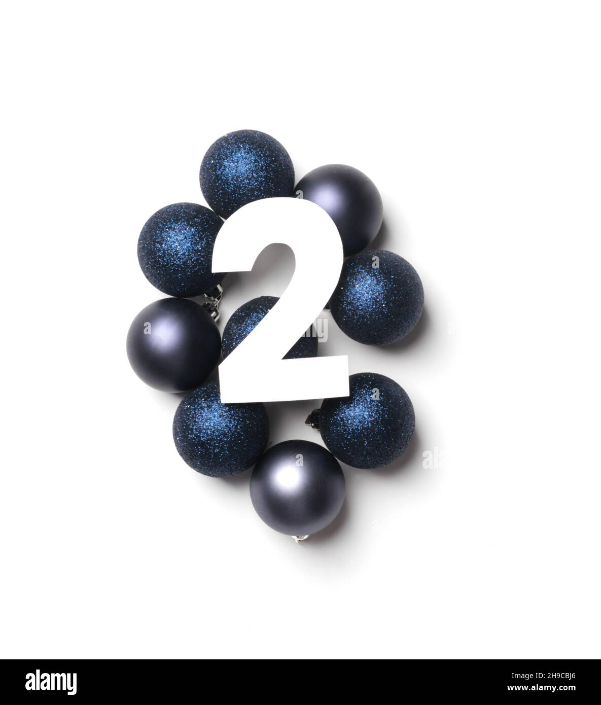 New year number 2 on blue holiday balls. White background. Copy space ...