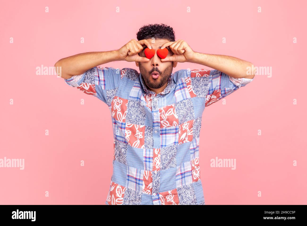 Portrait of bearded man with astonished facial expression, keeping lips ...