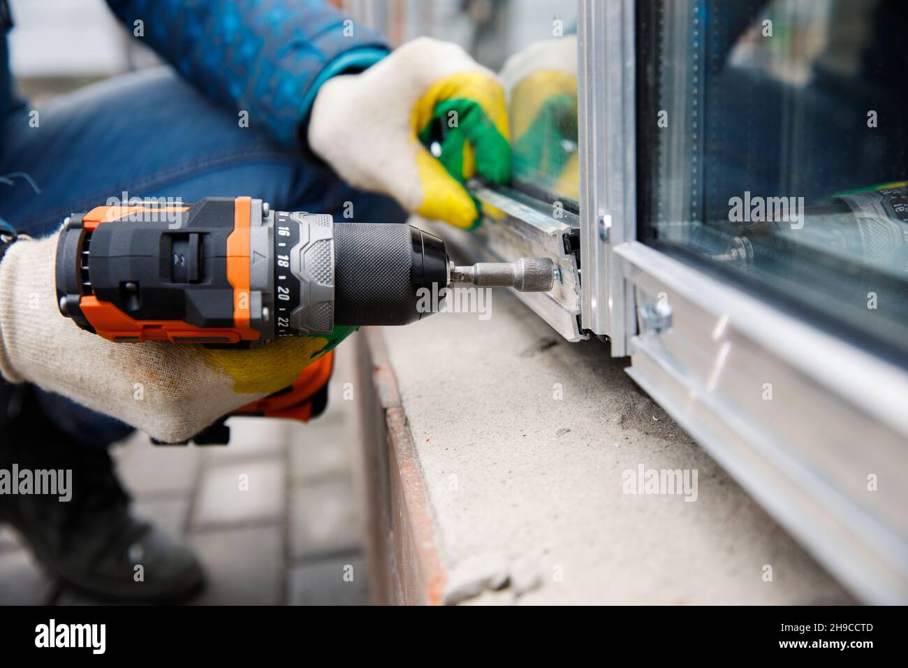 The wizard is engaged in installing windows. Repair work Stock Photo ...