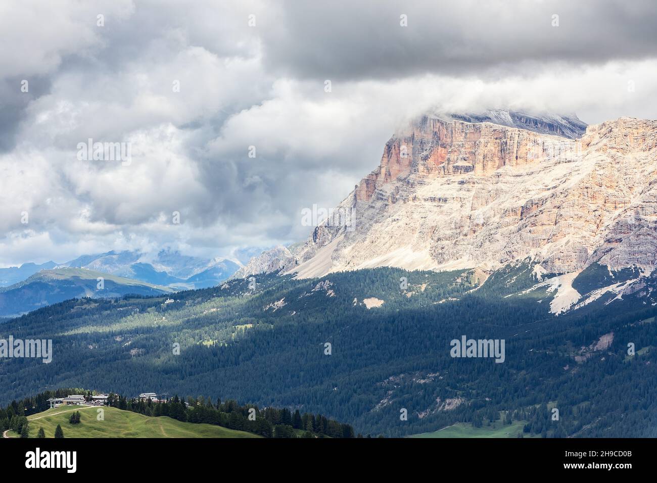 View of the cliff of the Italian Dolomites covered with low clouds ...