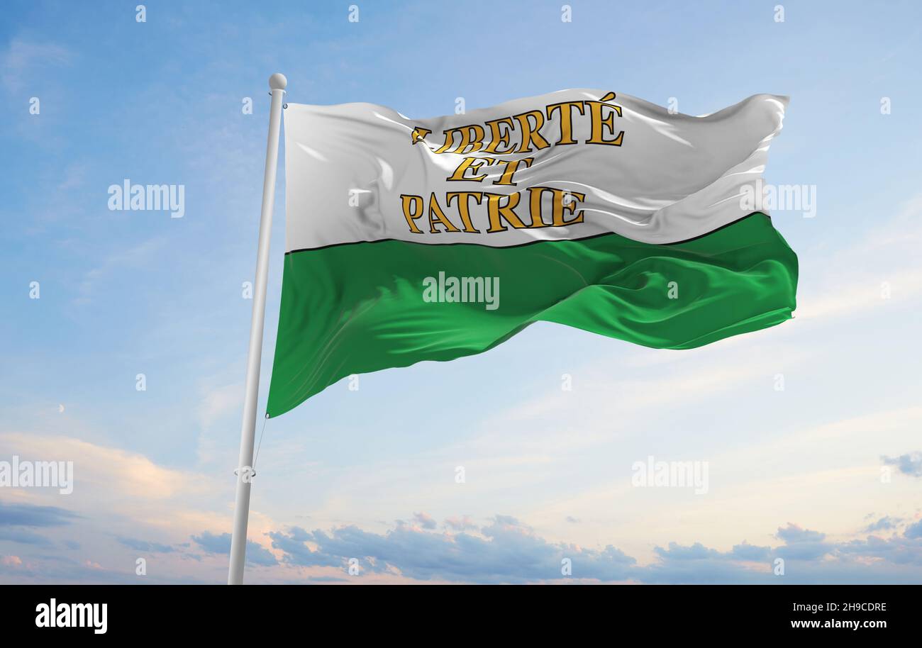 flag of Canton of Vaud , Switzerland at cloudy sky background on sunset ...