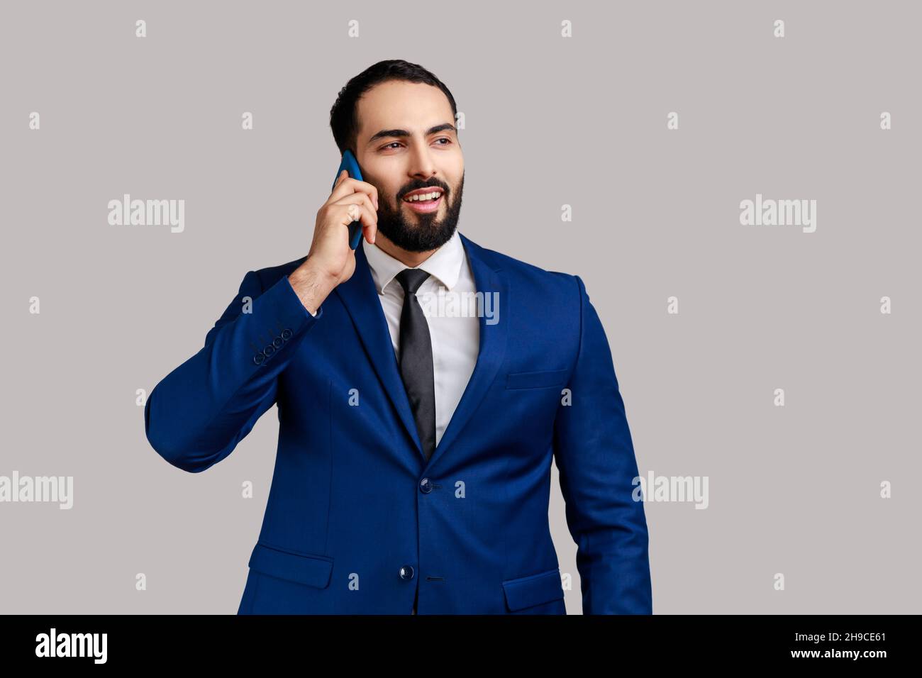 Smiling man standing, talking smartphone, making call and having ...