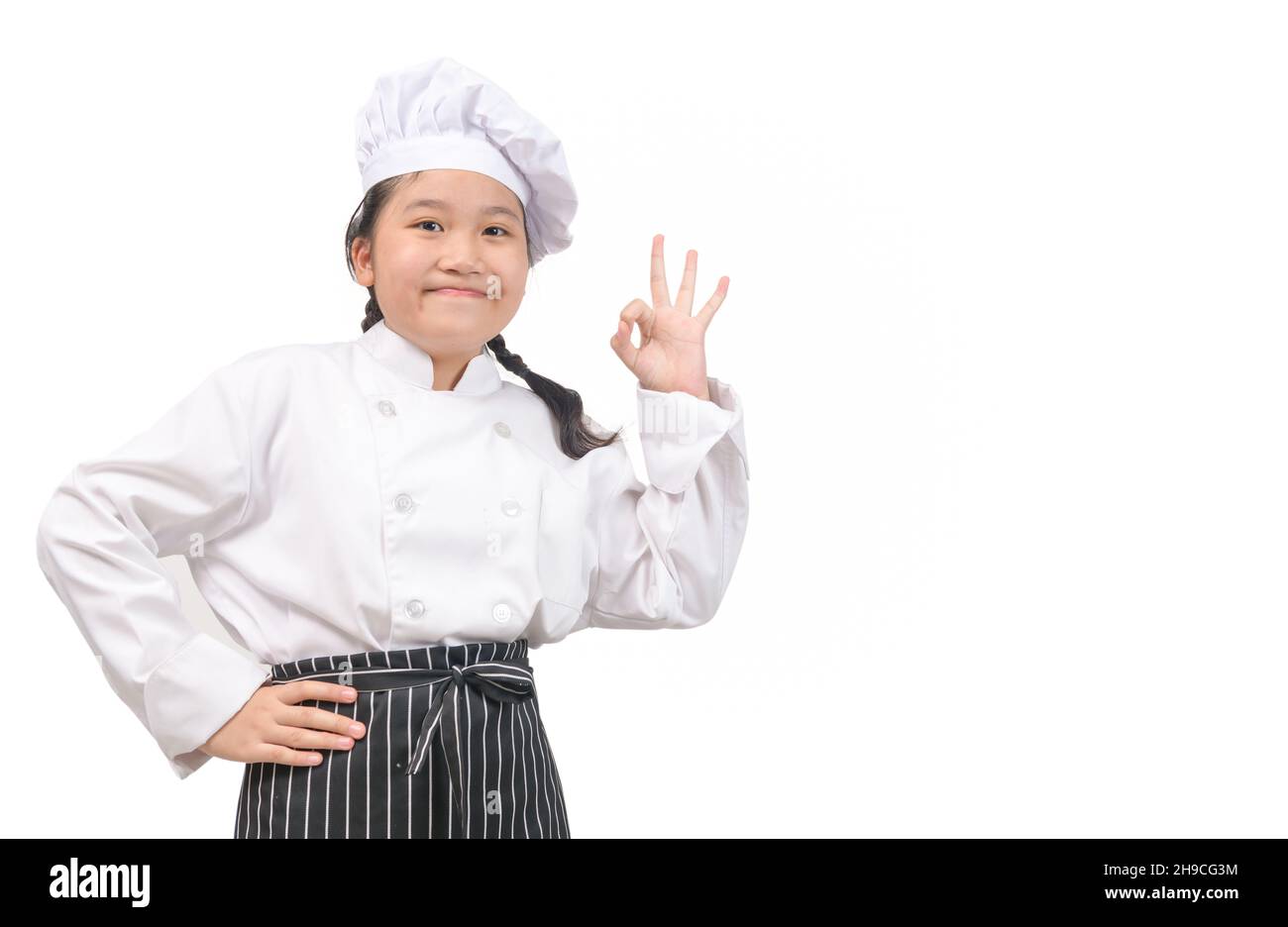 Smiling cute girl chef showing ok hand sign isolated on white ...