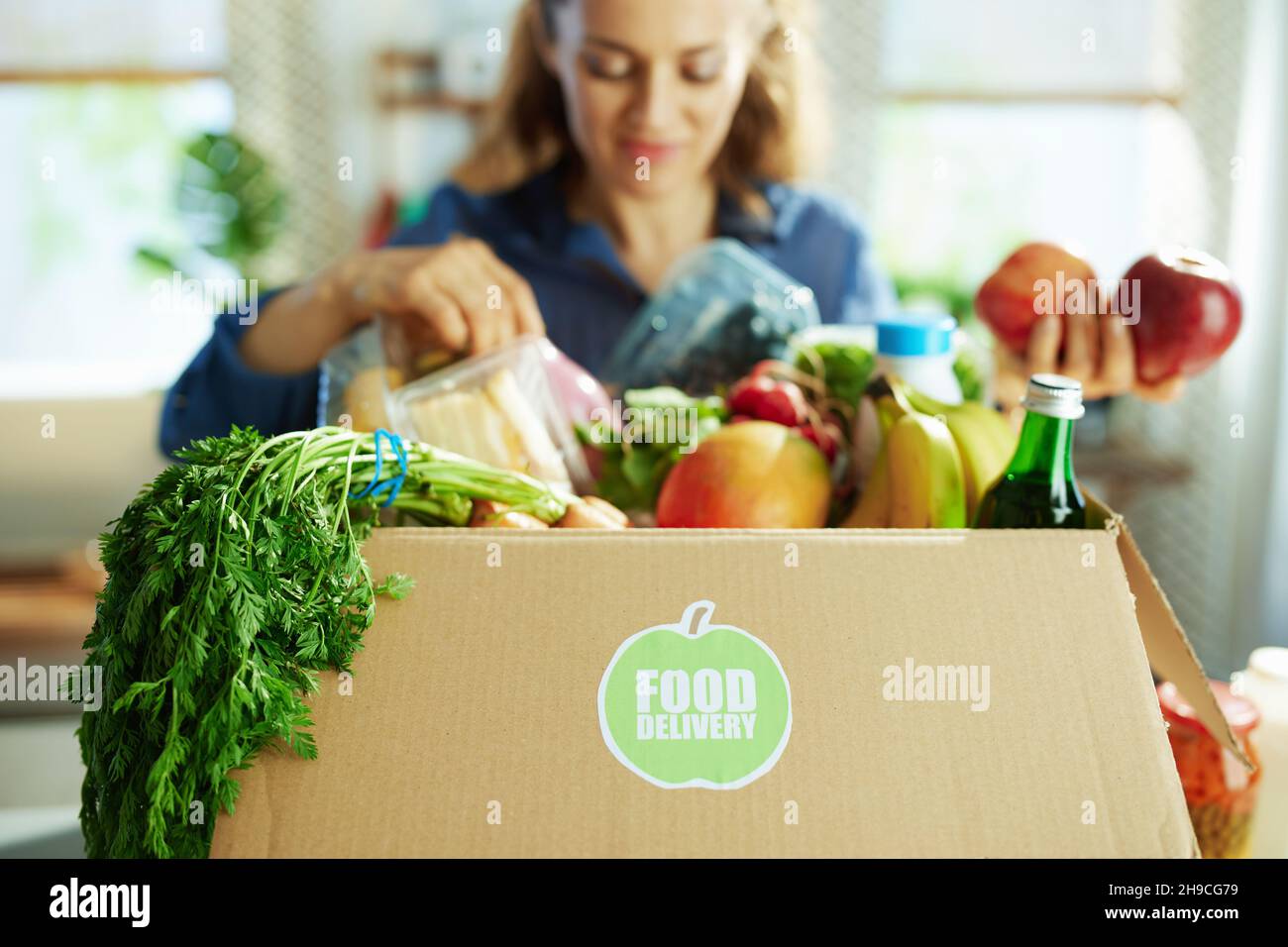 Food delivery. Closeup on woman with food box in the kitchen Stock ...