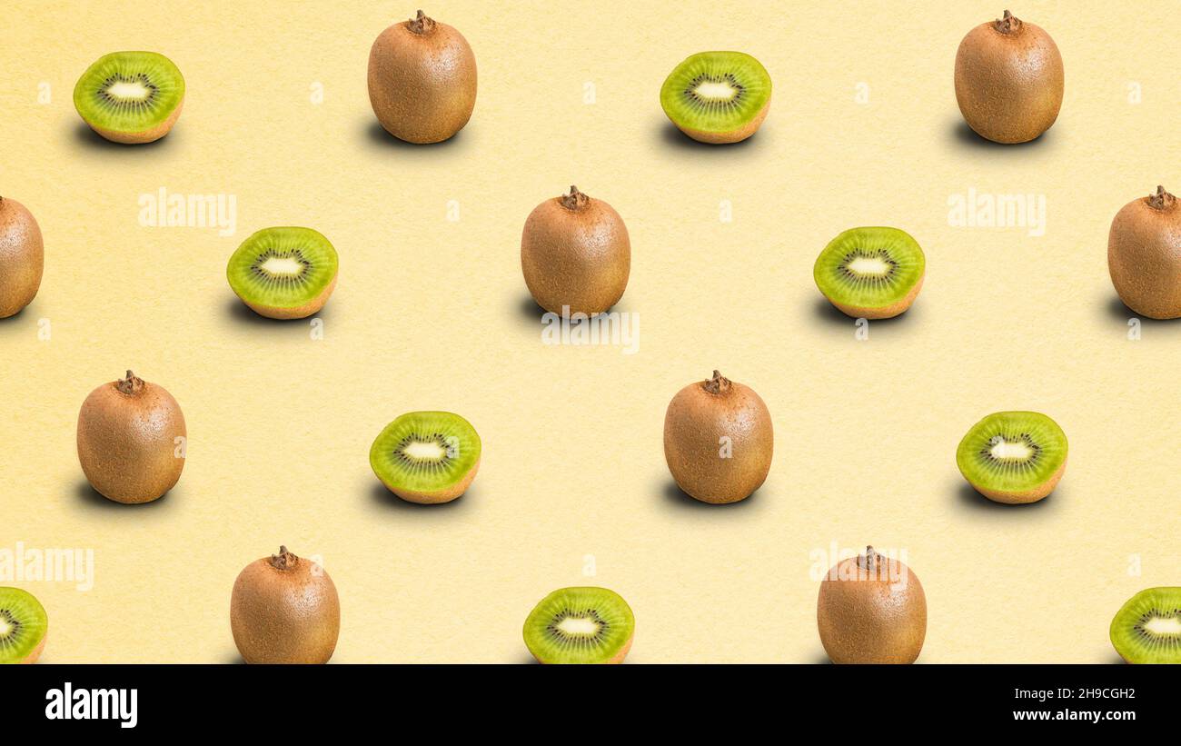 Repeated pattern of many whole and sliced ripe kiwi fruits on light ...