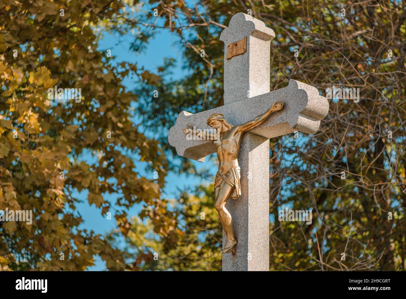 Crucifixion, statue of Jesus Christ on concrete cross on cemetery, selective focus Stock Photo ...