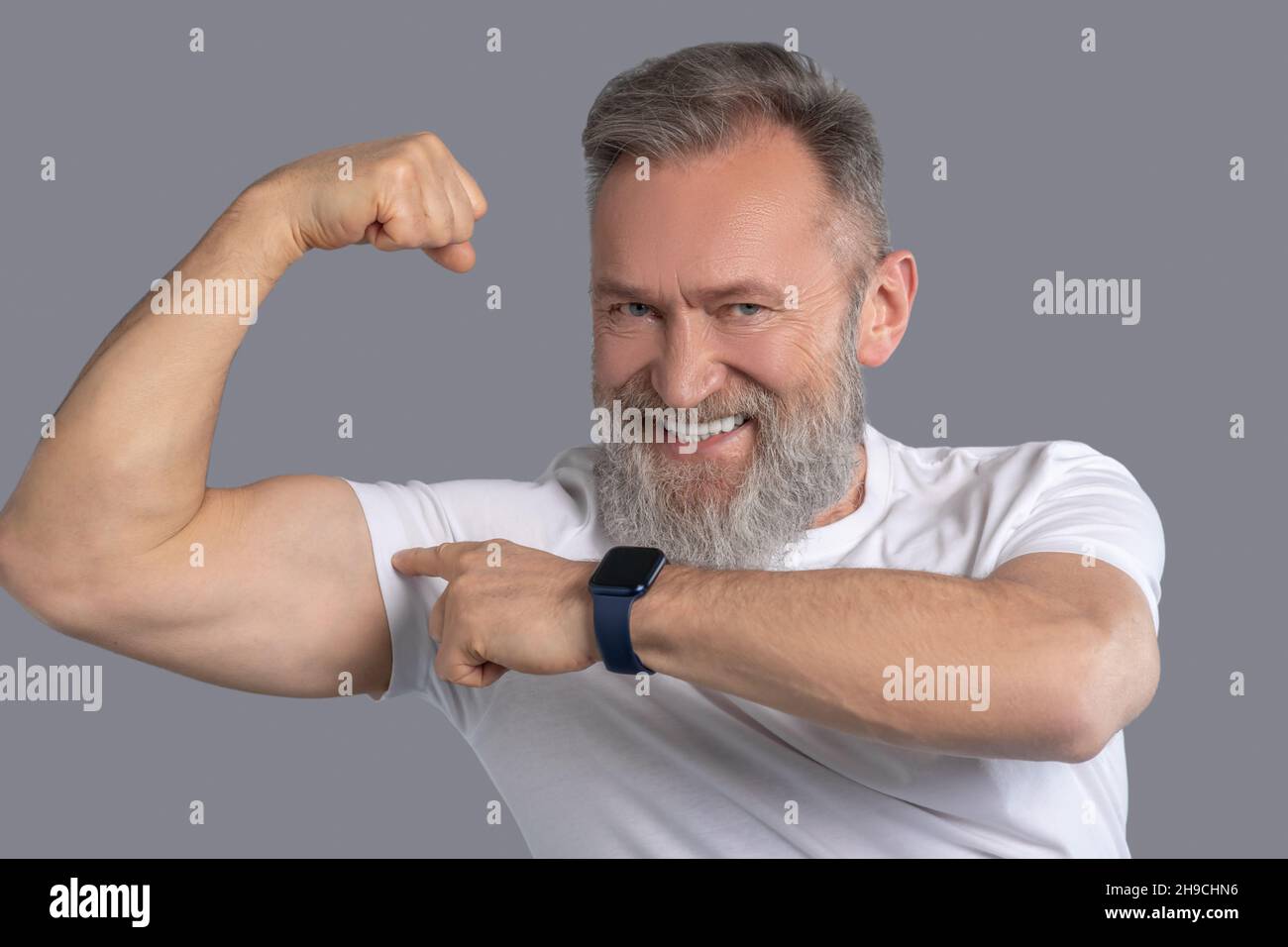 Bearded male showing biceps hi-res stock photography and images - Alamy