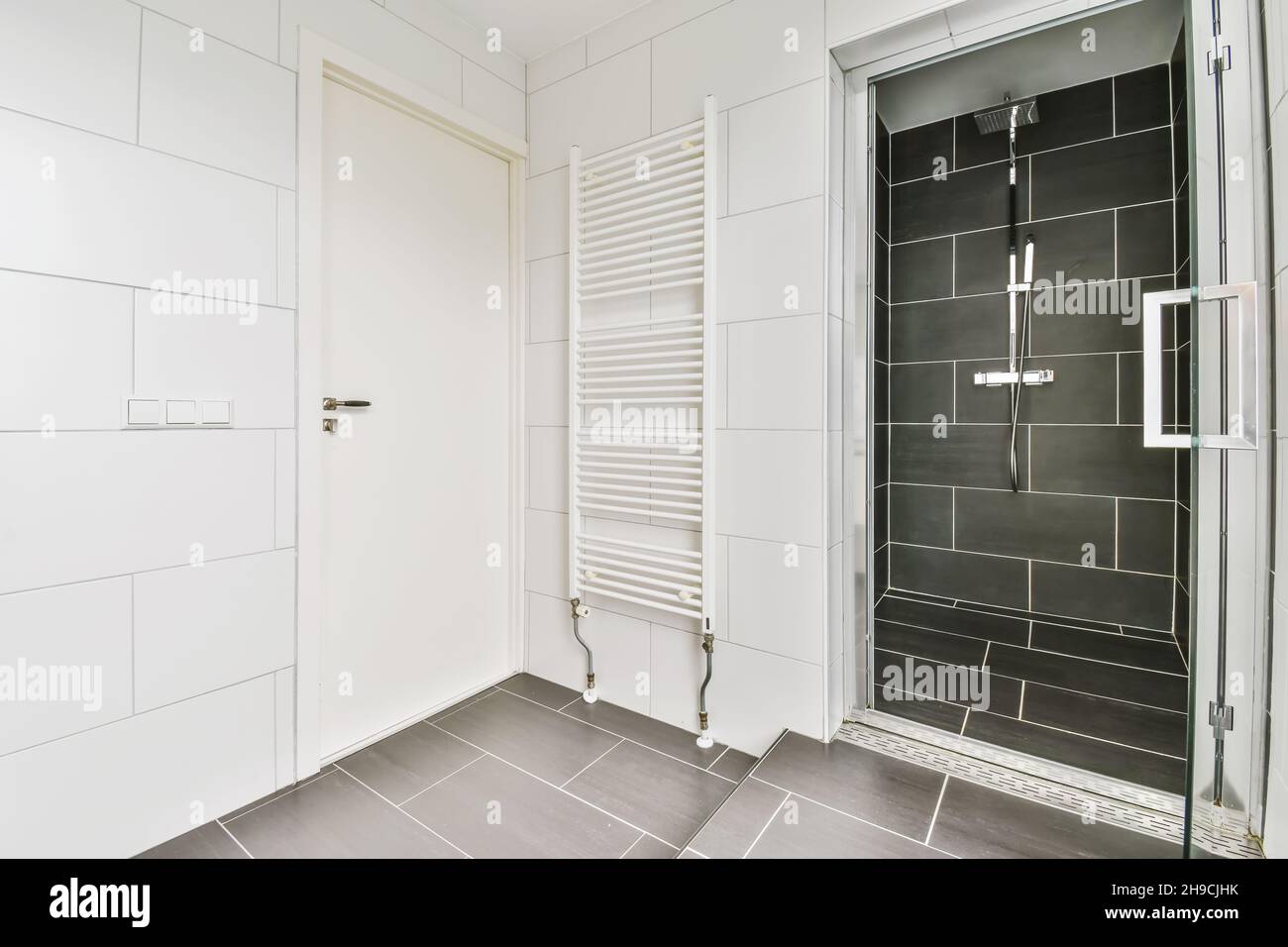 Lovely bathroom with black floor and walk-in shower, fully tiled with ...