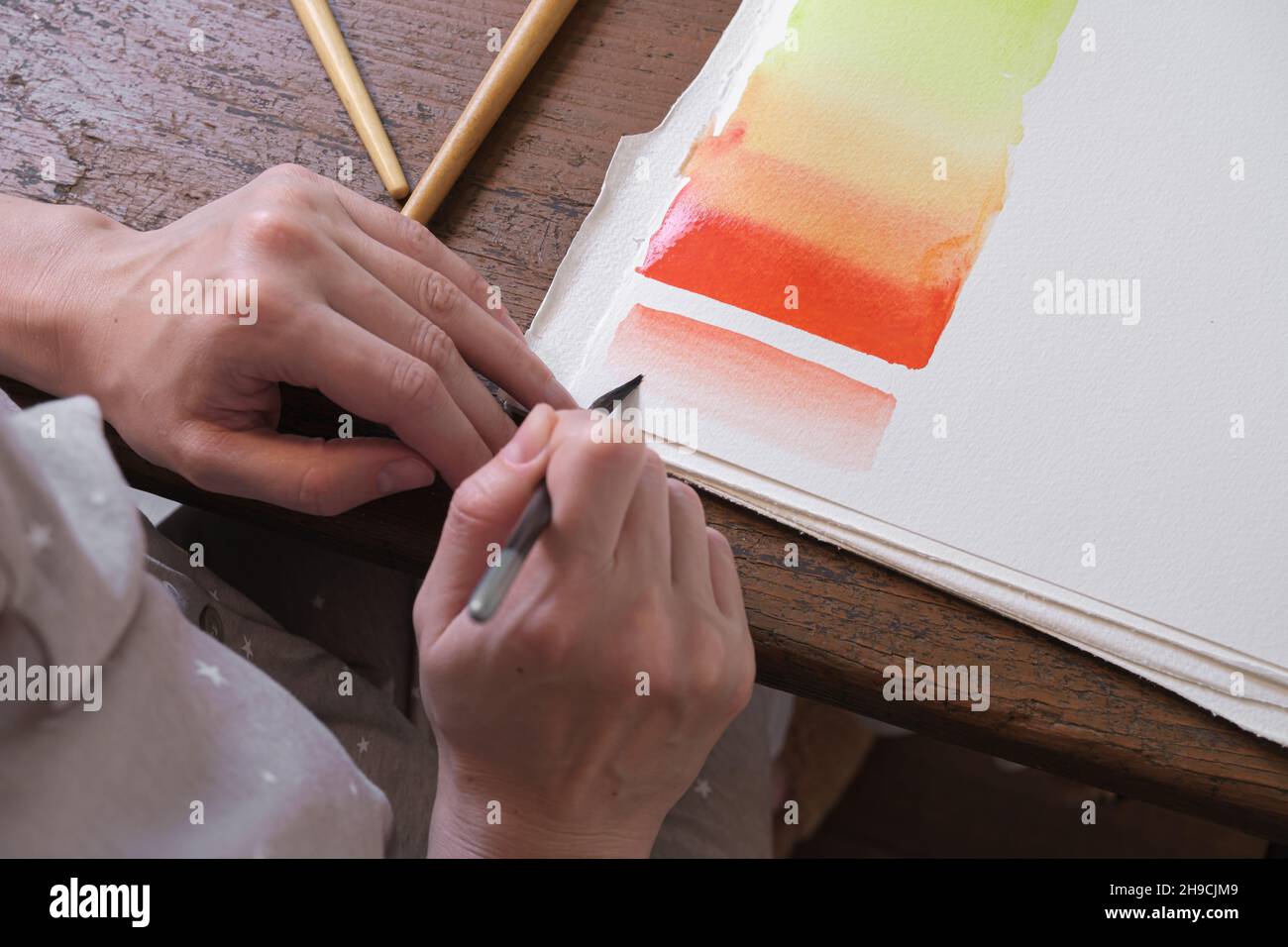 Artist draws colorful gradients in watercolor paint on a white canvas ...