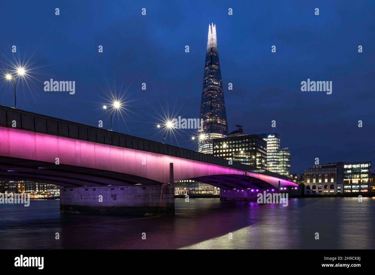 London skyline with London Bridge illuminated pink and the Shard Stock ...