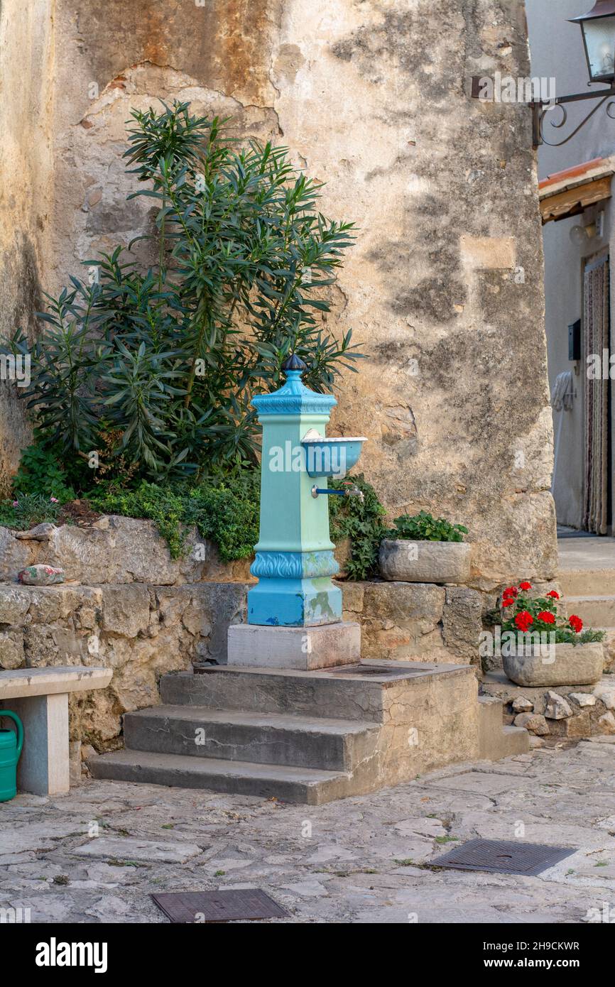 Blue antique water column with faucet. Old vintage water tap in ...