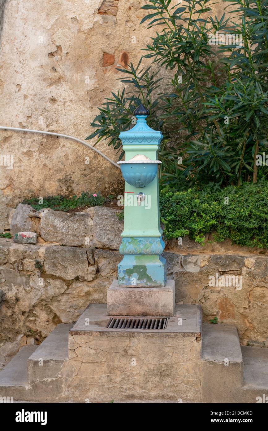 Blue antique water column with faucet. Old vintage water tap in ...