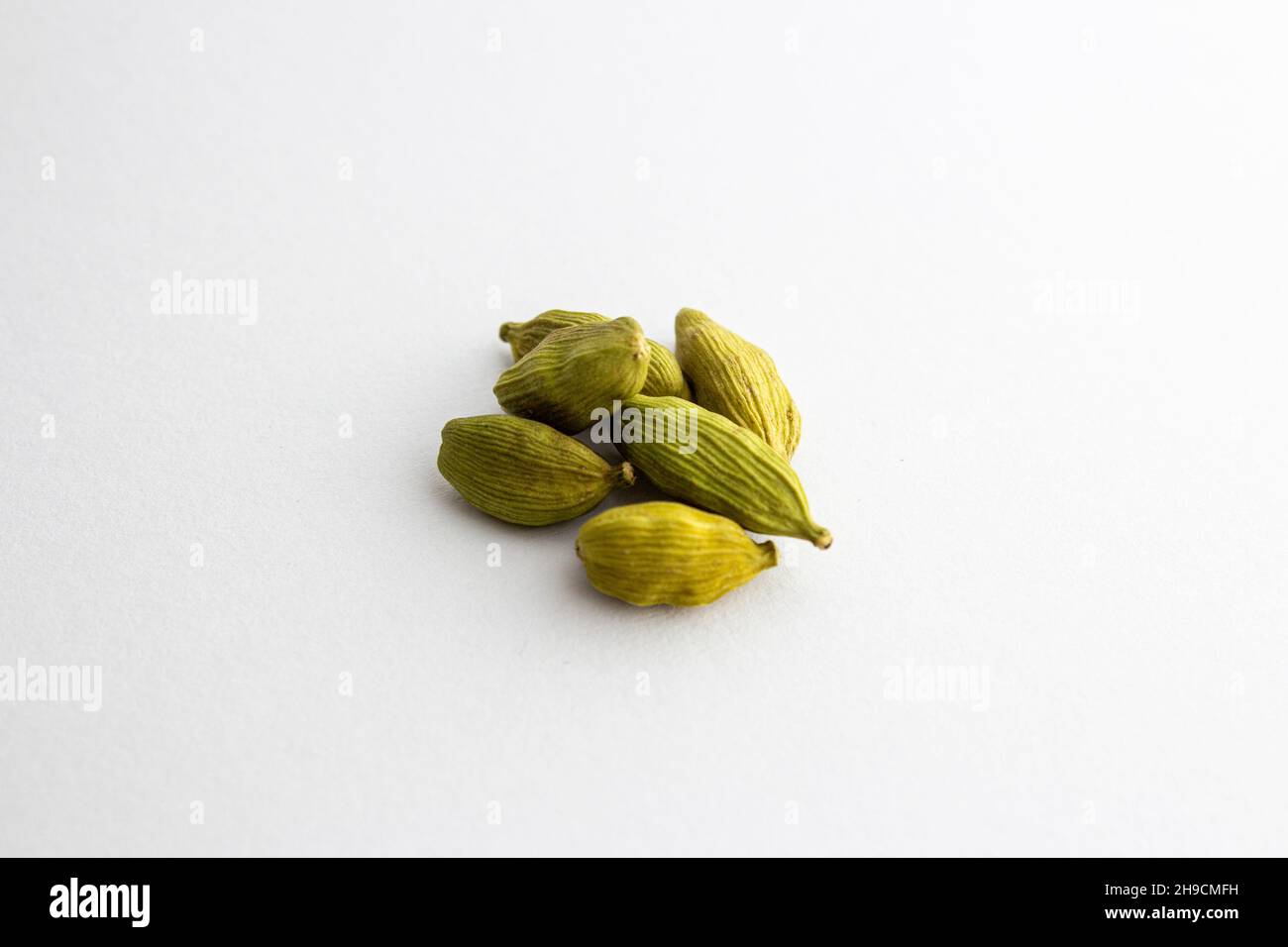 Pile of whole cardamom isolated on white background Stock Photo - Alamy