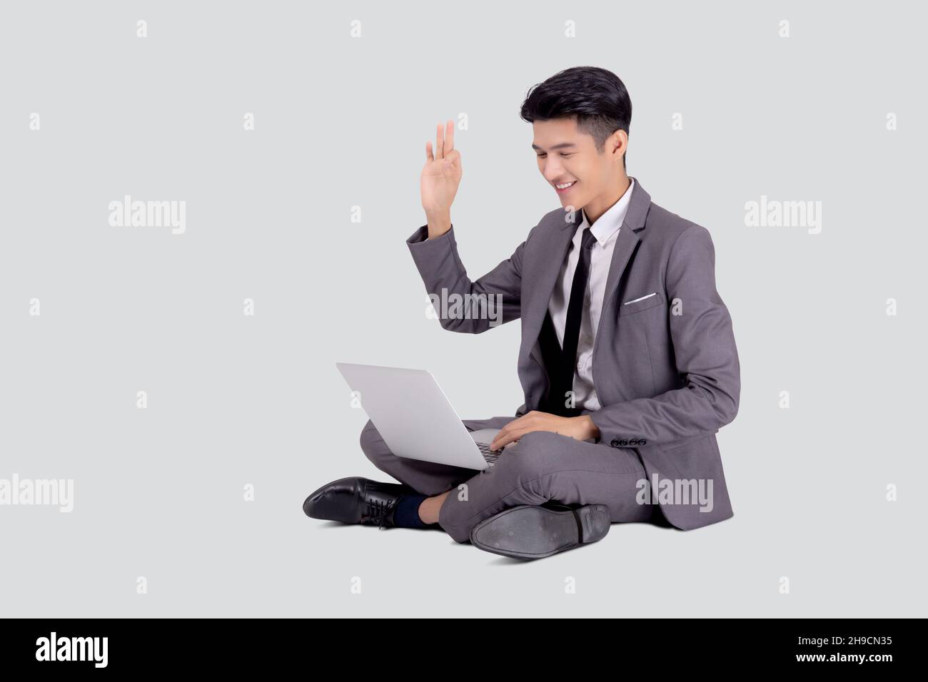 Young asian business man sitting work on laptop computer to internet ...