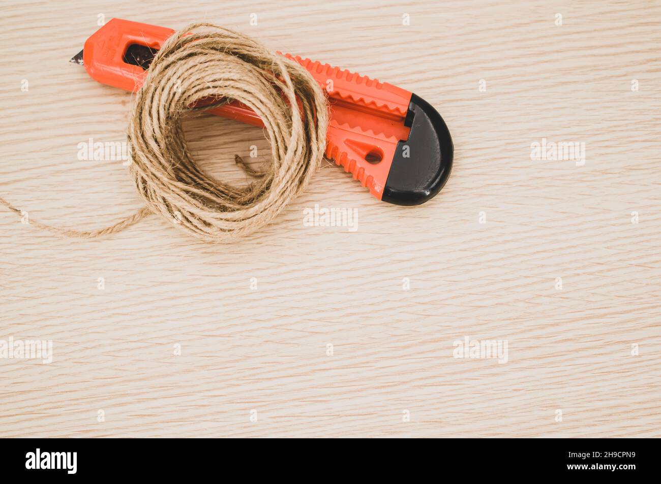cutter and rough string on a wooden worktop Stock Photo - Alamy