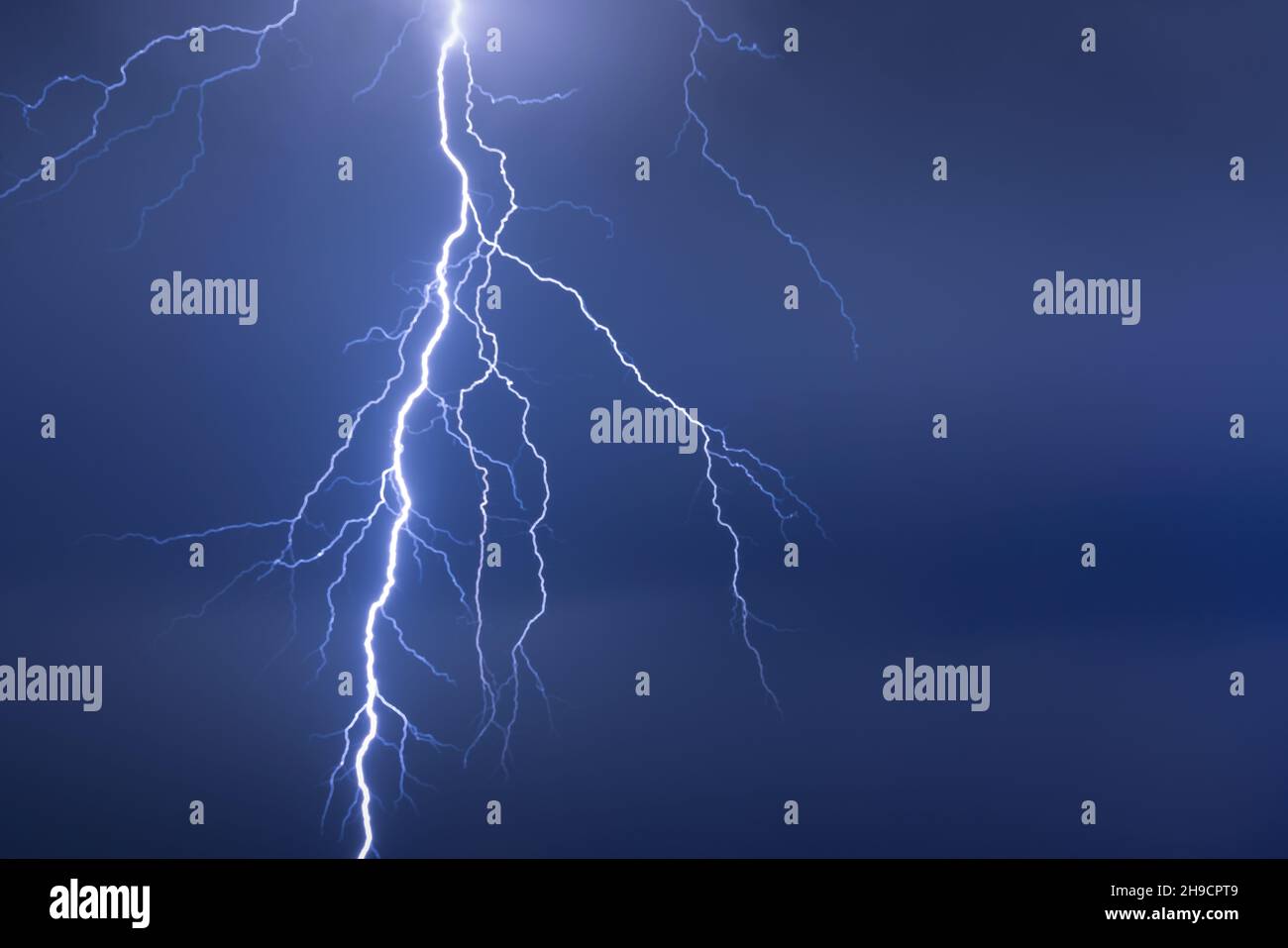 Lightning or thunderbolt in night storm in dramatic blue light Stock ...