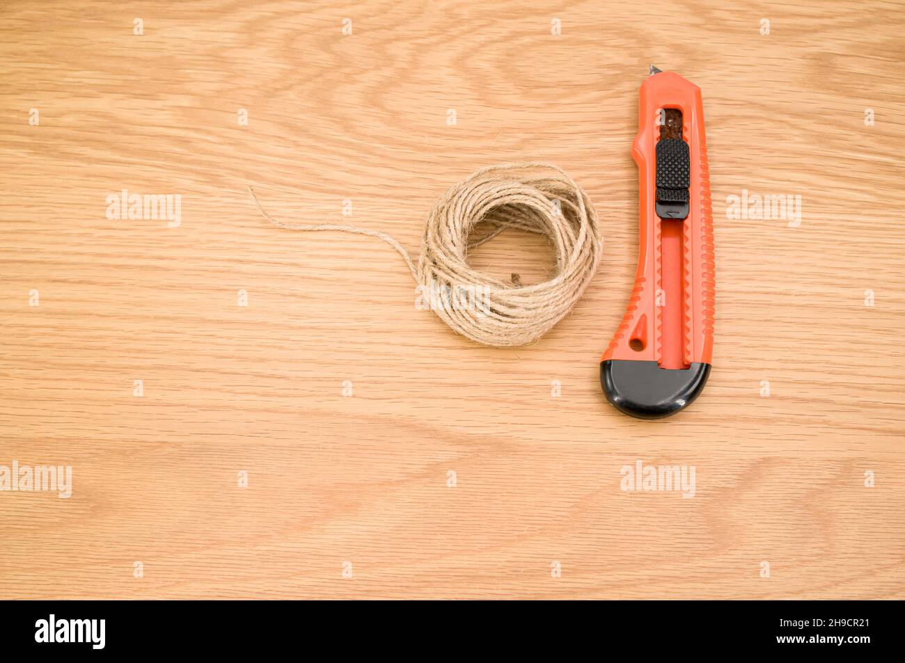 cutter and rough string on a wooden tabletop Stock Photo - Alamy