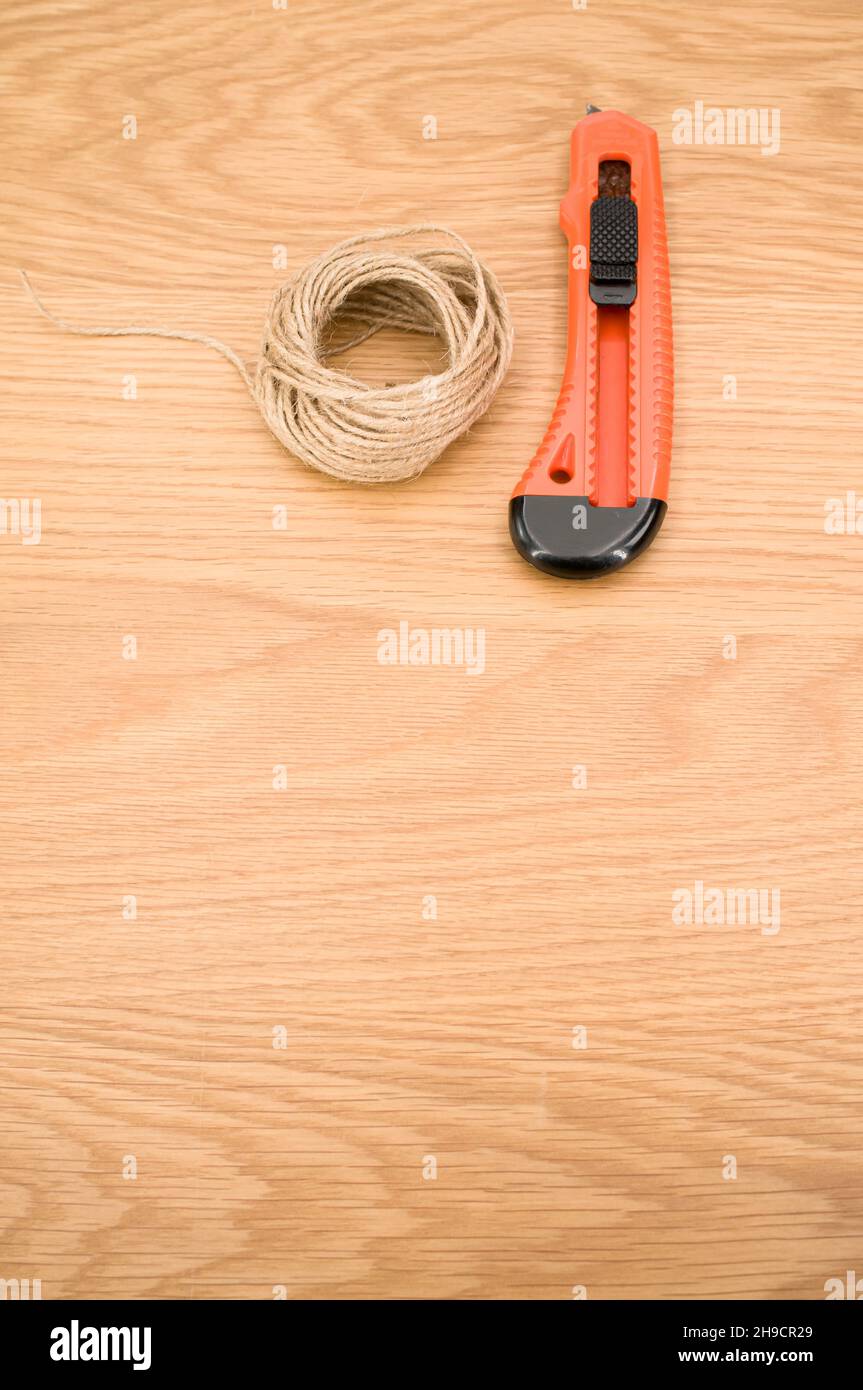 cutter and rough string on a wooden tabletop Stock Photo - Alamy
