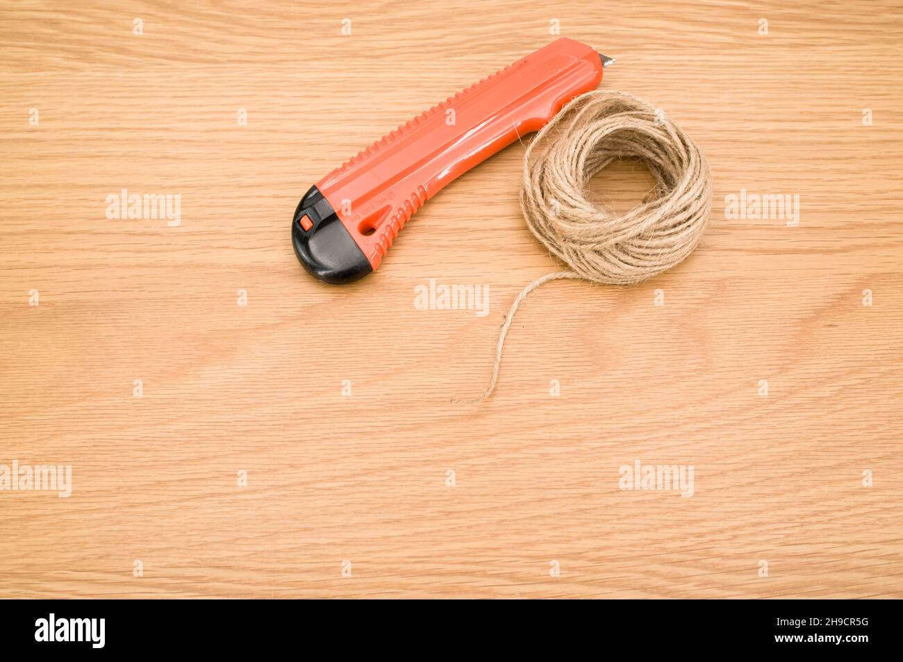cutter and rough string on a wooden tabletop background Stock Photo - Alamy