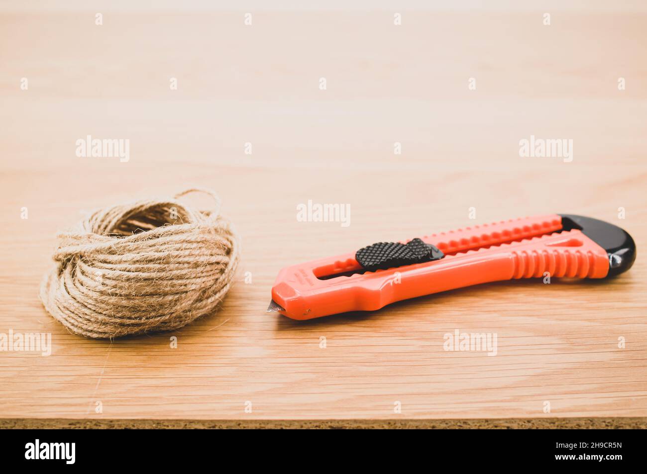 cutter and rough string on a wooden tabletop Stock Photo - Alamy