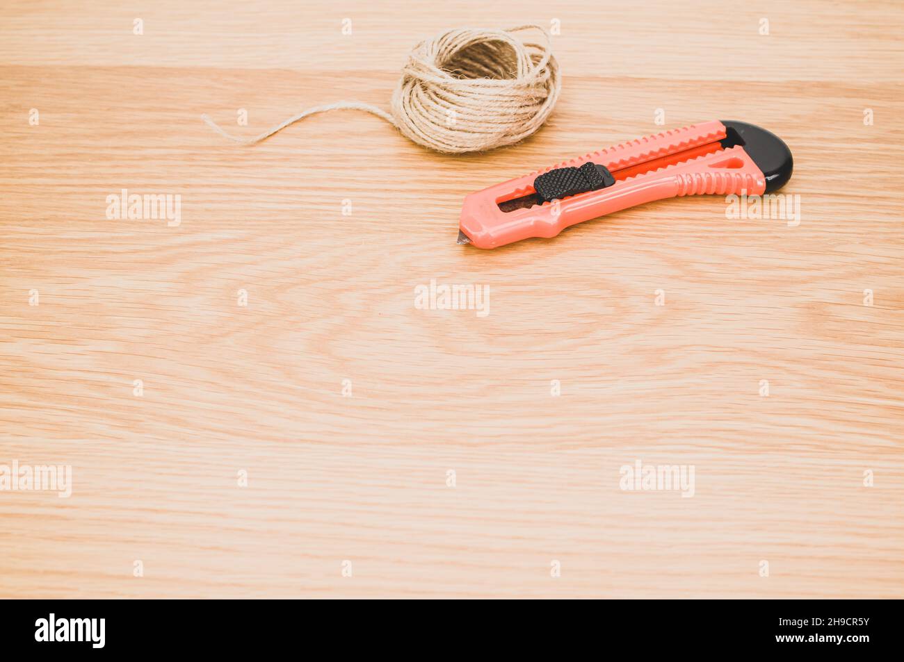 cutter and rough string on a wooden tabletop Stock Photo - Alamy