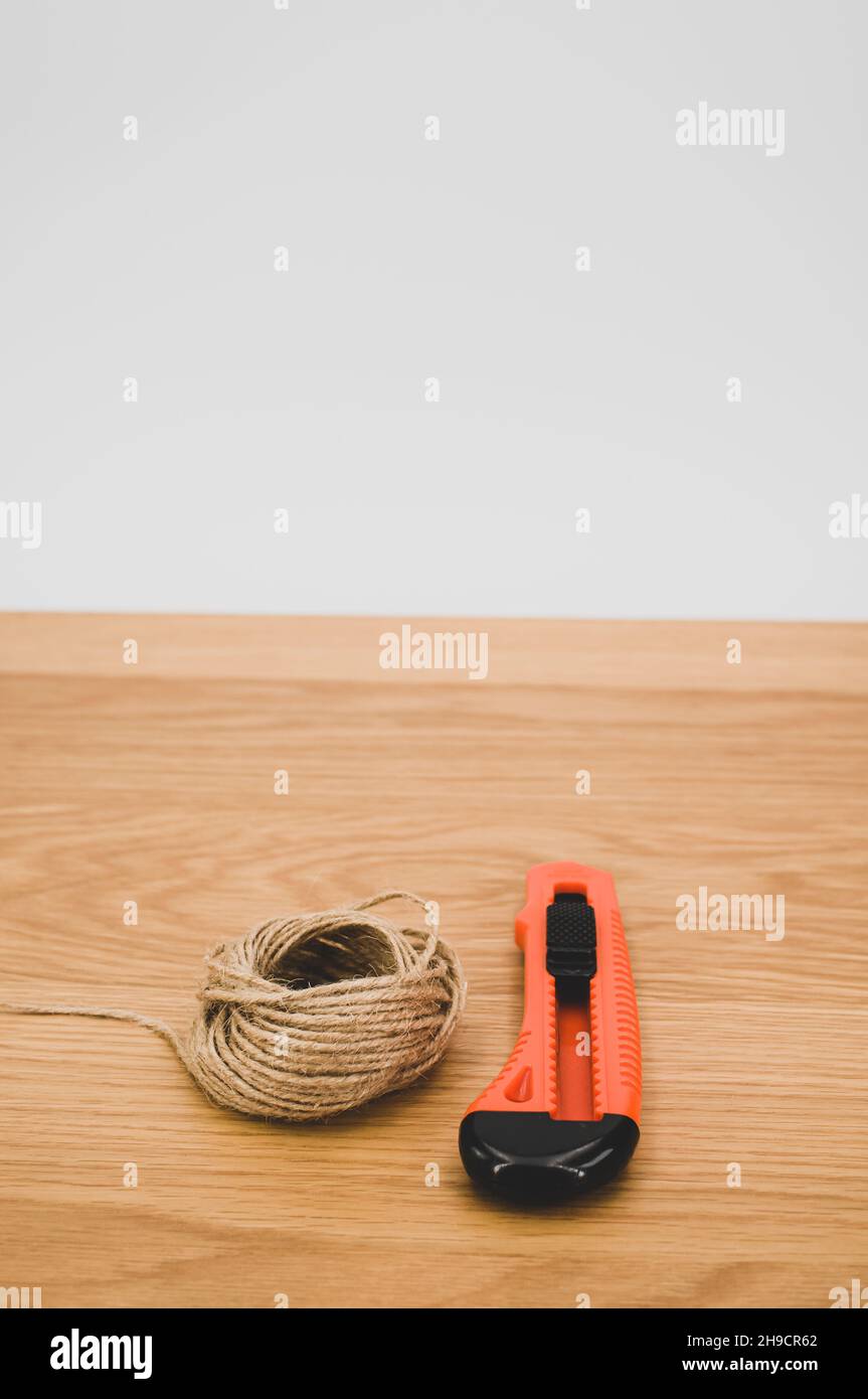 cutter and rough string on a wooden tabletop Stock Photo - Alamy