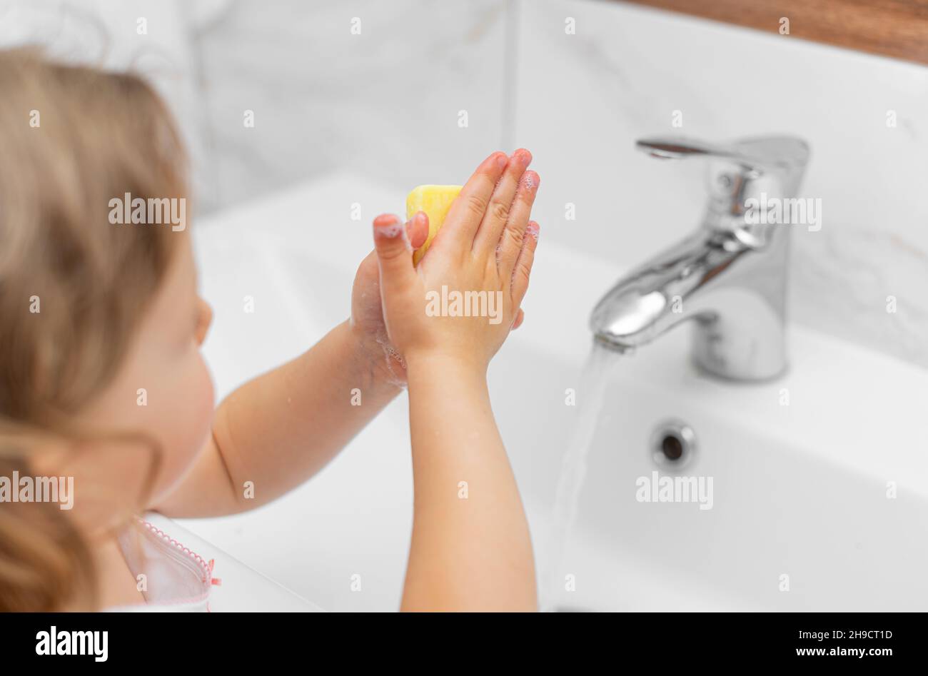 The child washes his hands under the tap Stock Photo - Alamy