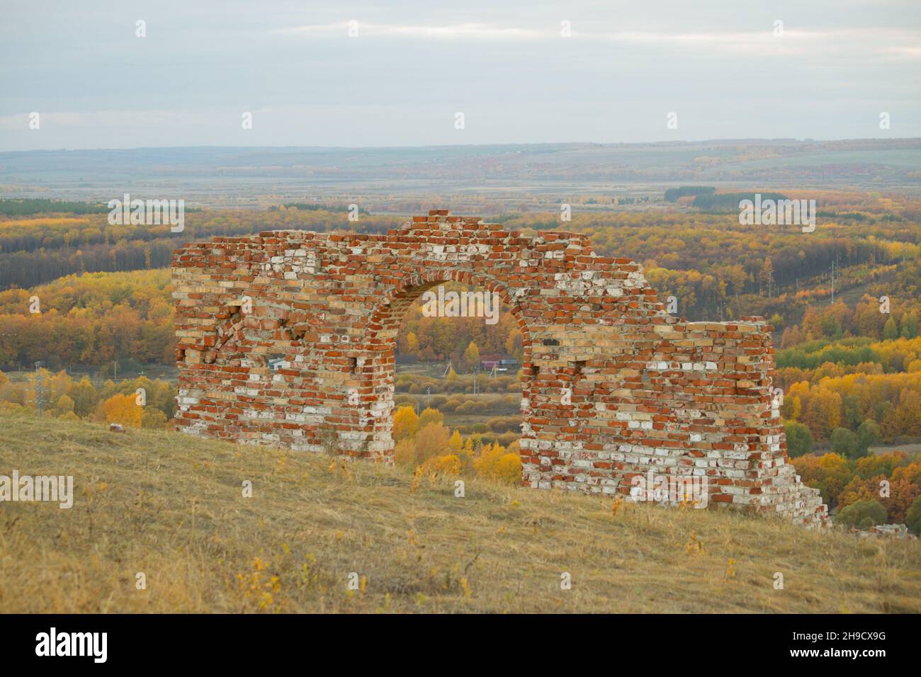 Old ruined arch and view on autumn forest Stock Photo - Alamy