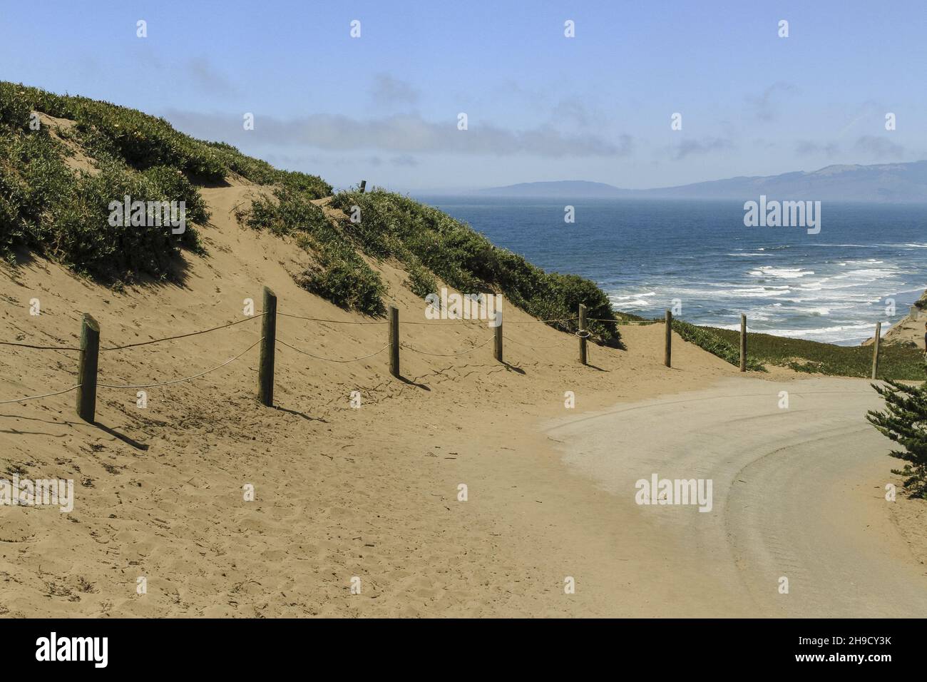 Sandy landscape and the sea under a clear sky in Northern California ...