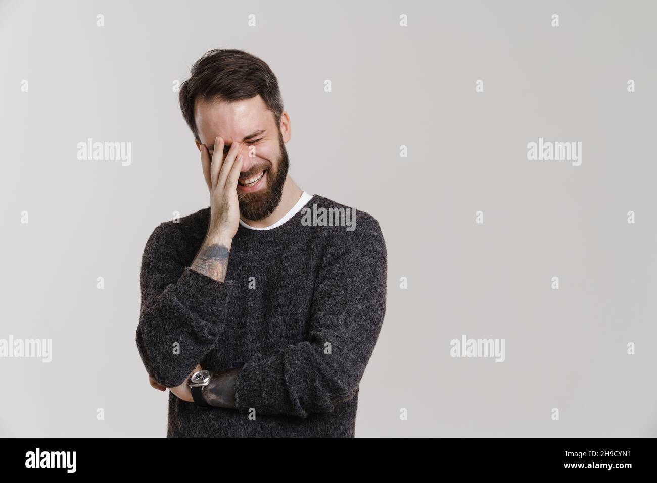 White mid man with beard laughing and cover his face isolated over ...