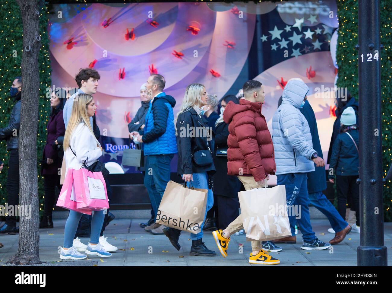Shoppers queue outside Selfridges department store as people walk on ...