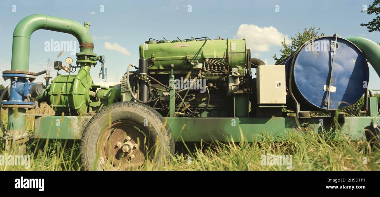 Old water pump machine in the green field Stock Photo - Alamy