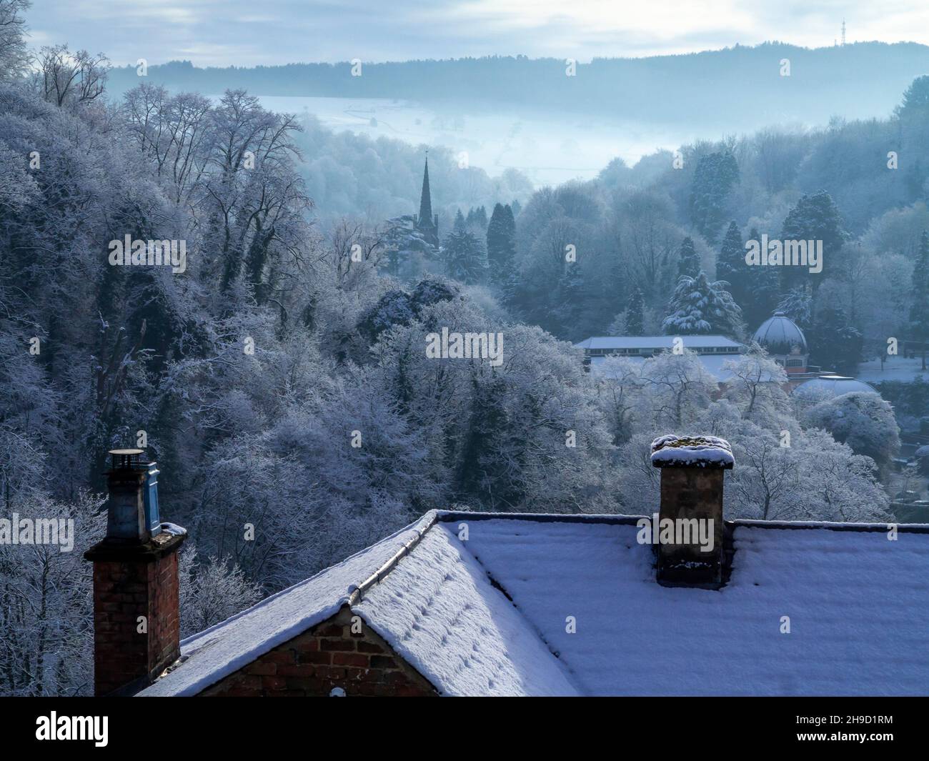 Snow covered landscape with trees and rooftops at Matlock Bath in the ...