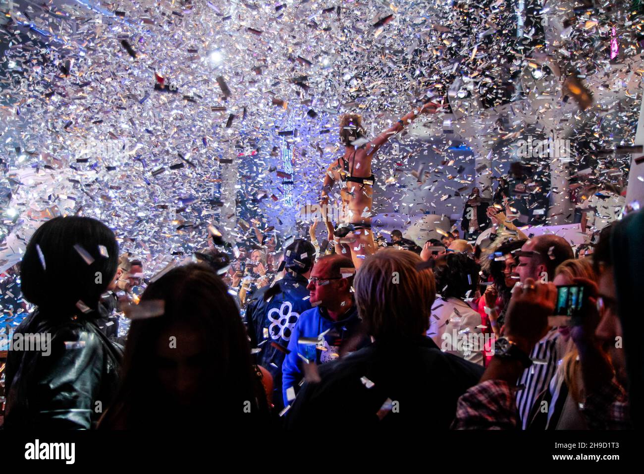 night party festival crowd of people silhouettes hands up with confetti ...