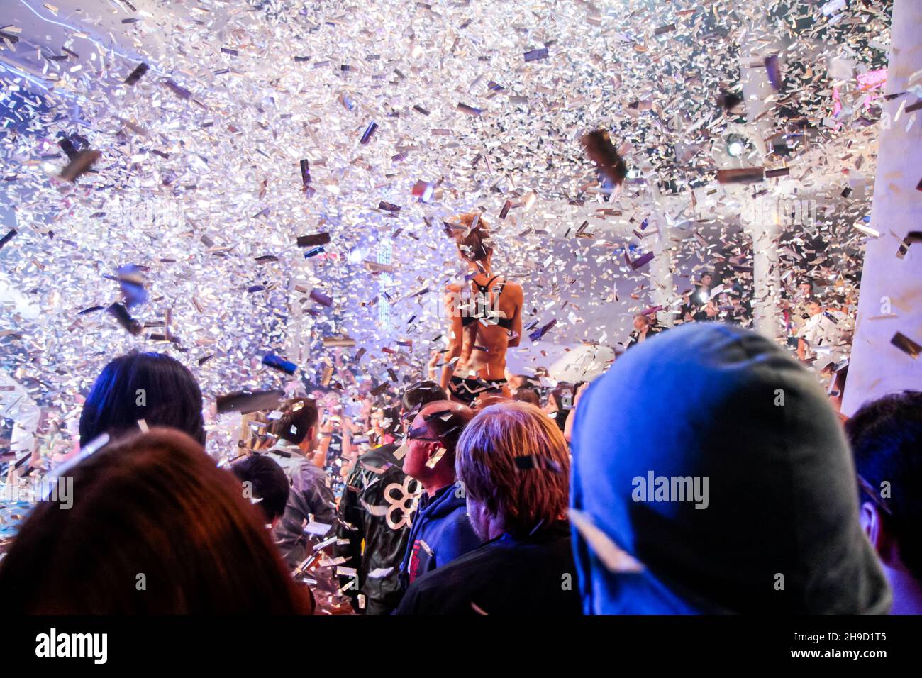 night party festival crowd of people silhouettes hands up with confetti ...