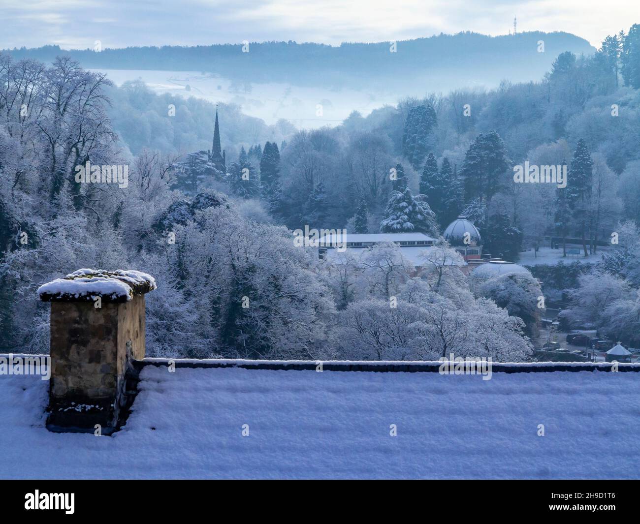 Snow covered landscape with trees and rooftops at Matlock Bath in the ...