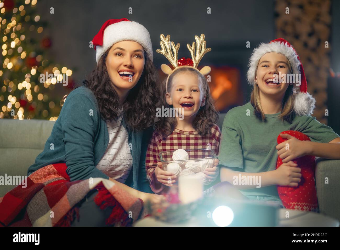Merry Christmas and Happy New Year. People having fun near tree indoors ...